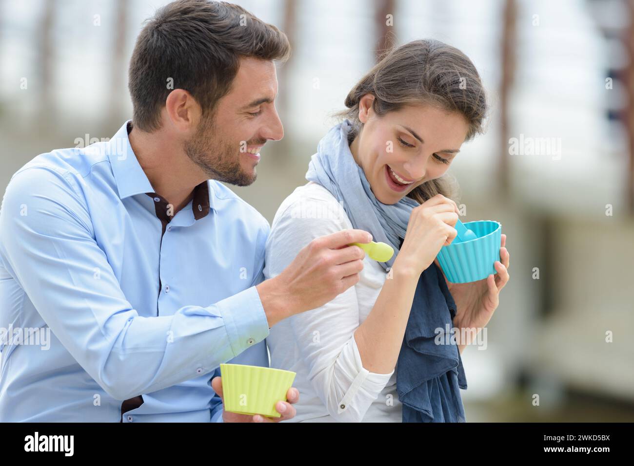man stealing girlfriends ice cream Stock Photo - Alamy