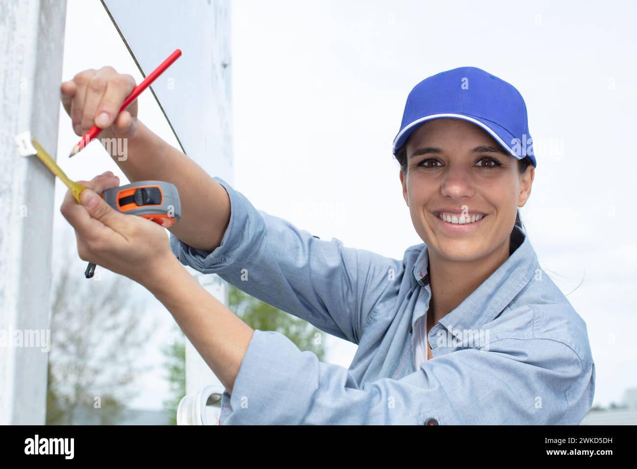 close-up woman measuring of metal plank Stock Photo - Alamy
