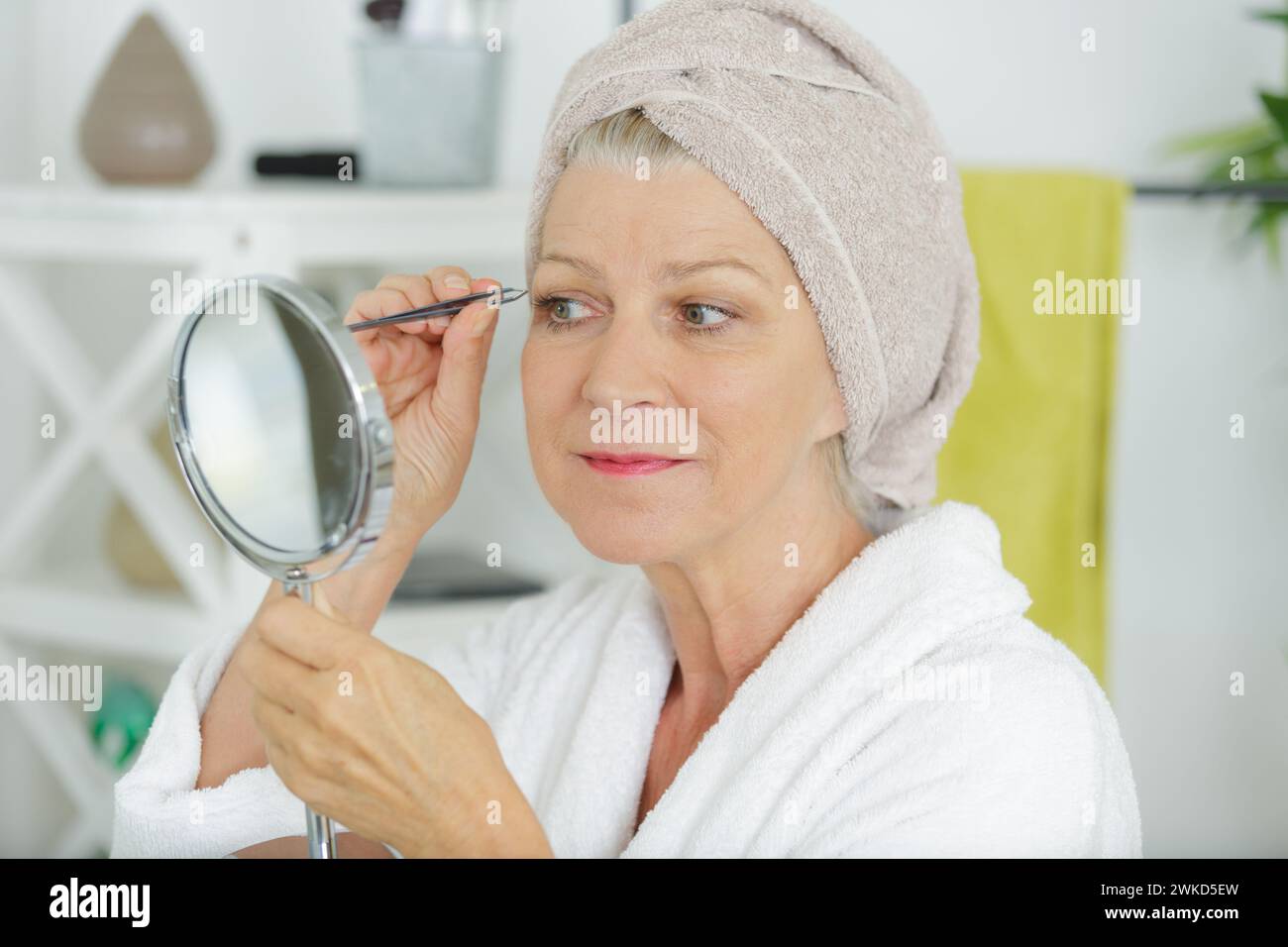 woman plucking eyebrows by the window Stock Photo - Alamy