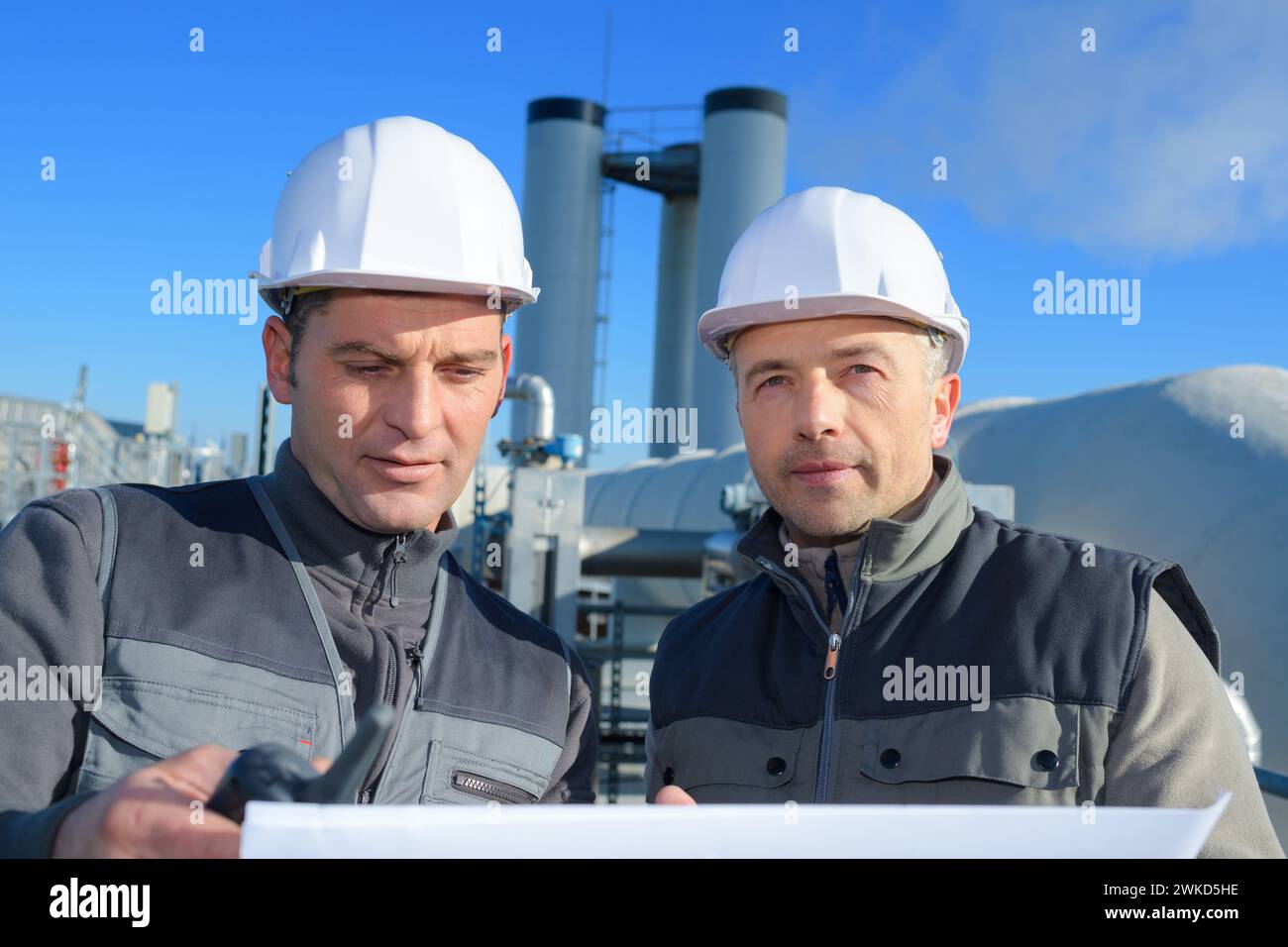 two workers in factory outdoors Stock Photo - Alamy