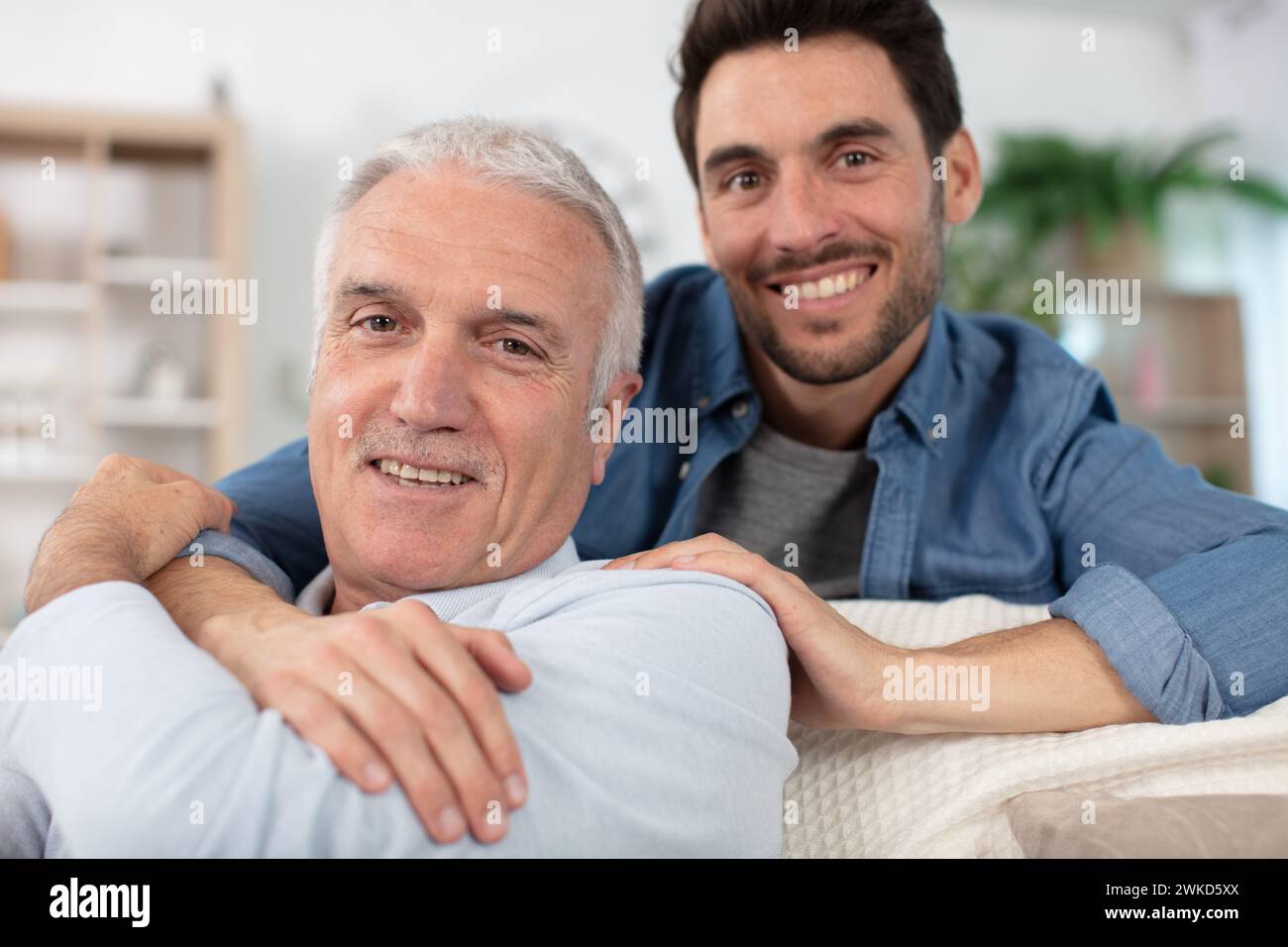 happy old senior dad embracing adult grown son Stock Photo - Alamy
