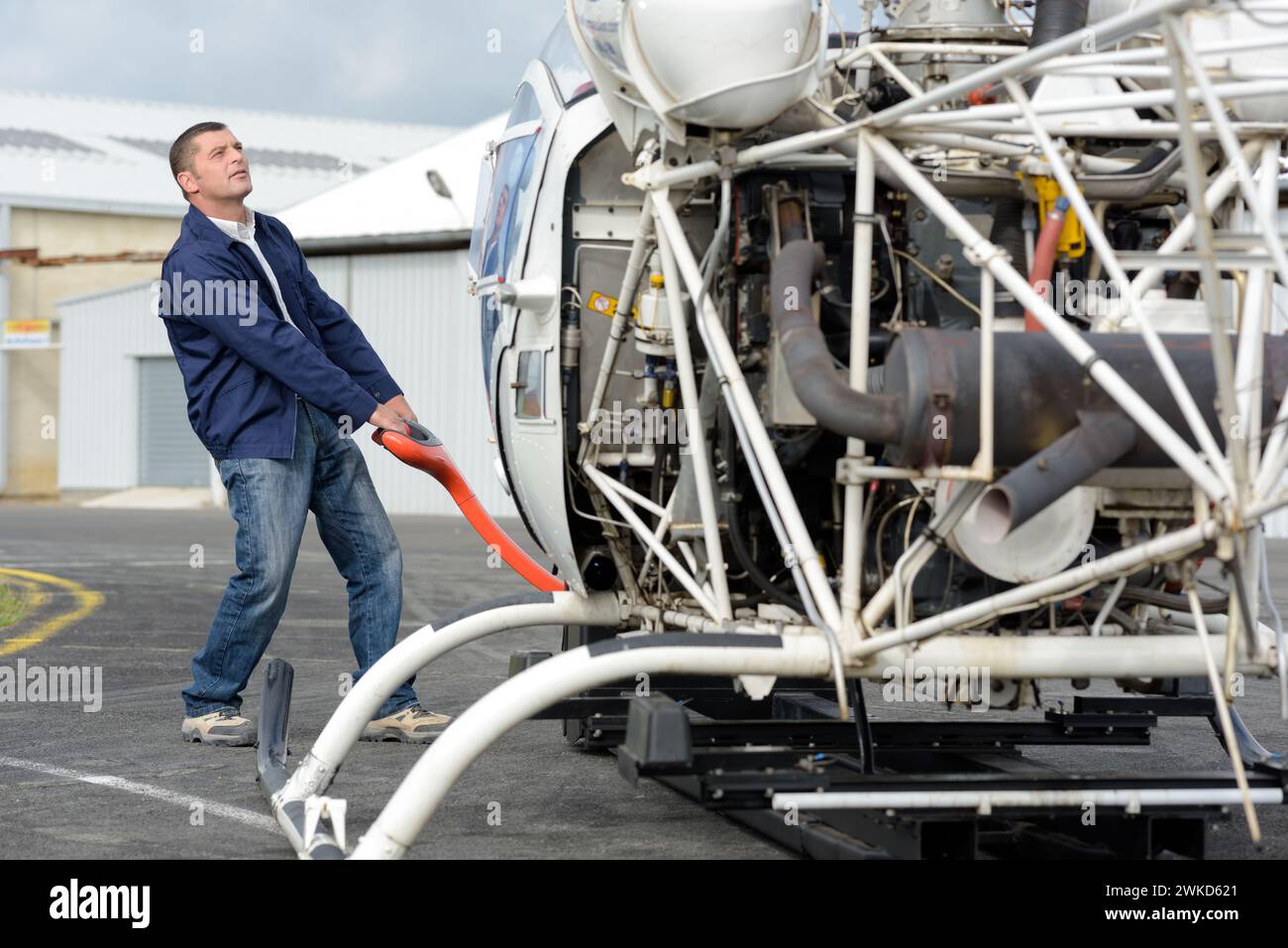 hangar worker and helicopter frame Stock Photo - Alamy