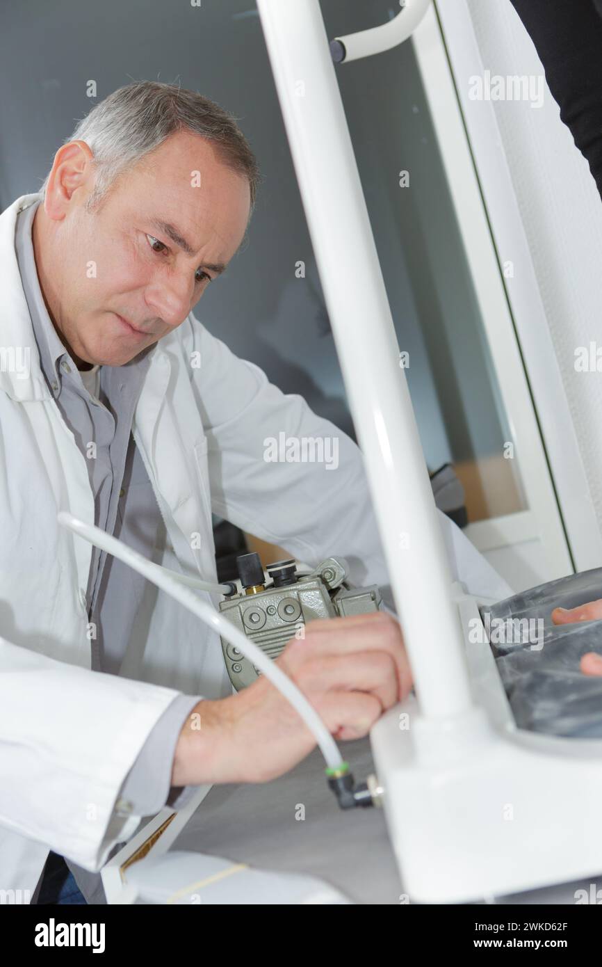 a doctor calibrating podiatrist machine Stock Photo - Alamy