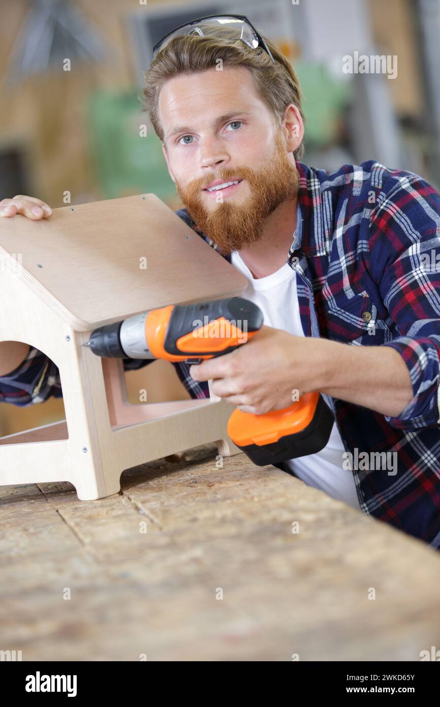 a man uses a screwdriver Stock Photo - Alamy