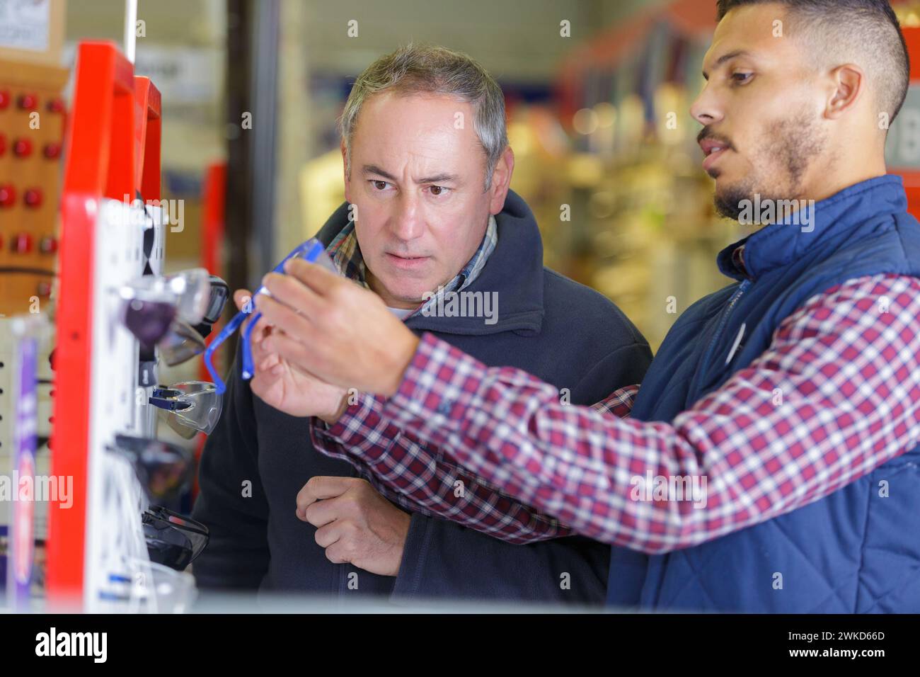 hardware store worker and buyer customer Stock Photo - Alamy