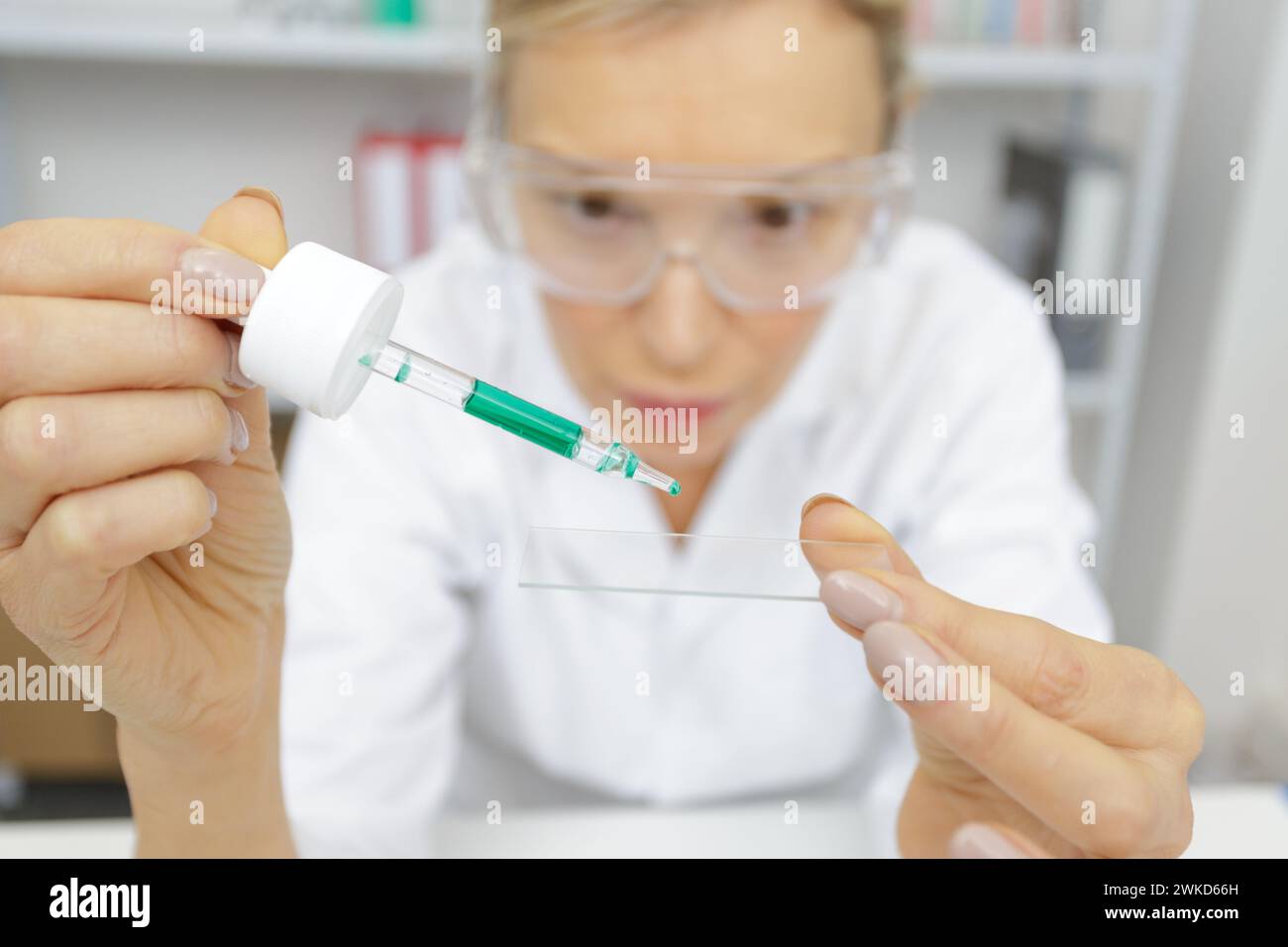 woman with pipette taking sample from test tube Stock Photo - Alamy