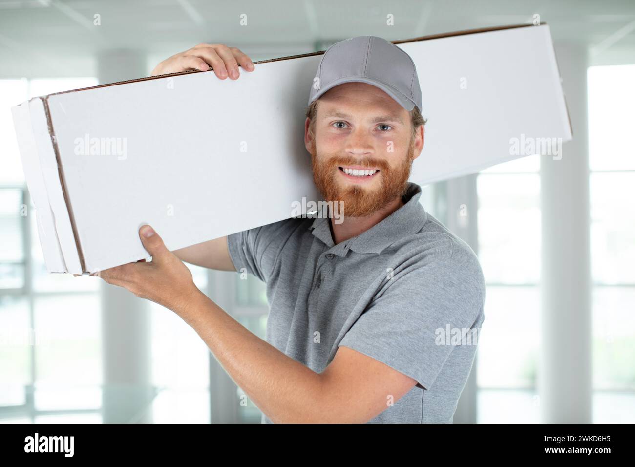 happy delivery man holding package Stock Photo - Alamy