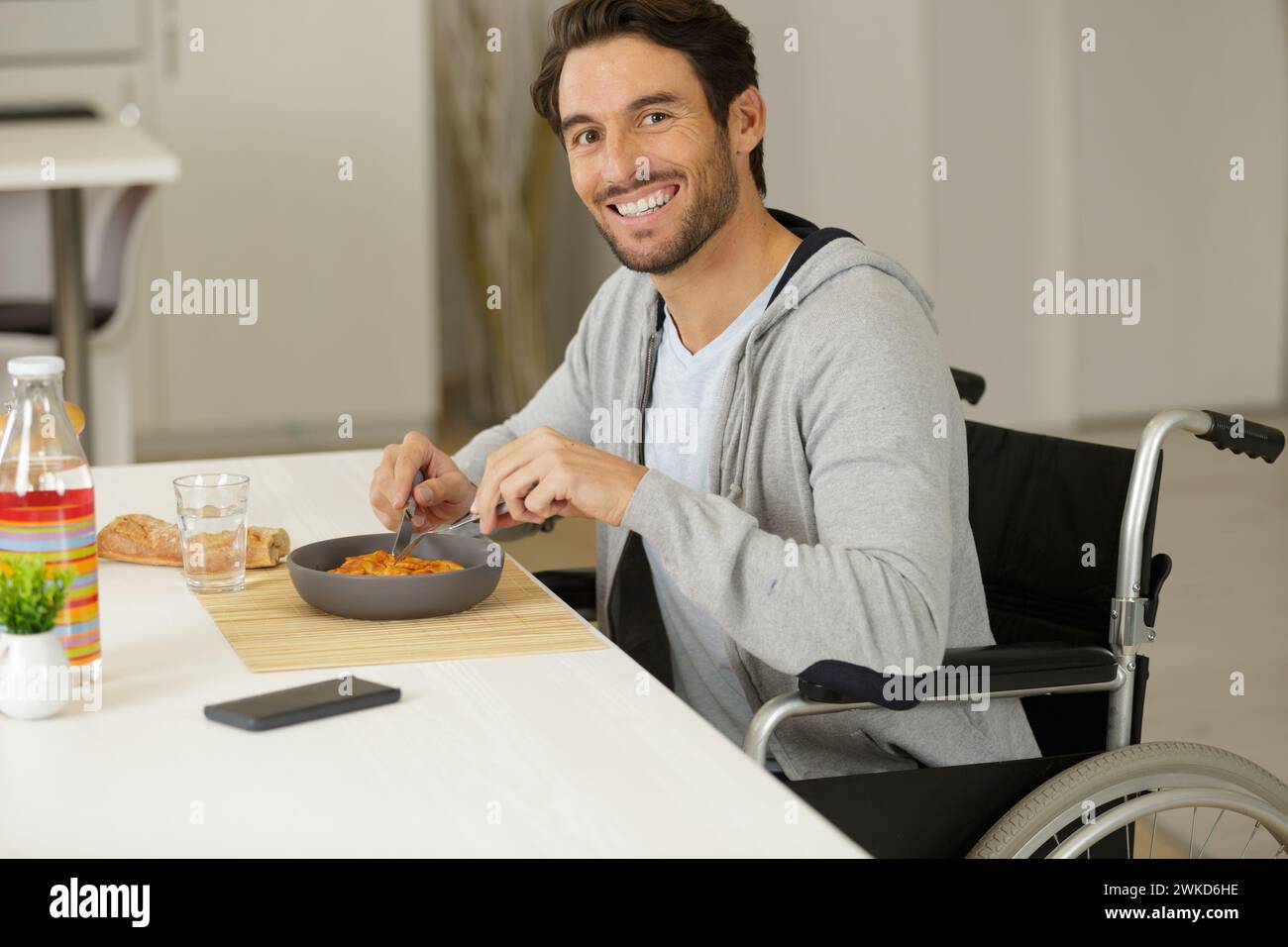 disabled man eating a meal at home Stock Photo - Alamy