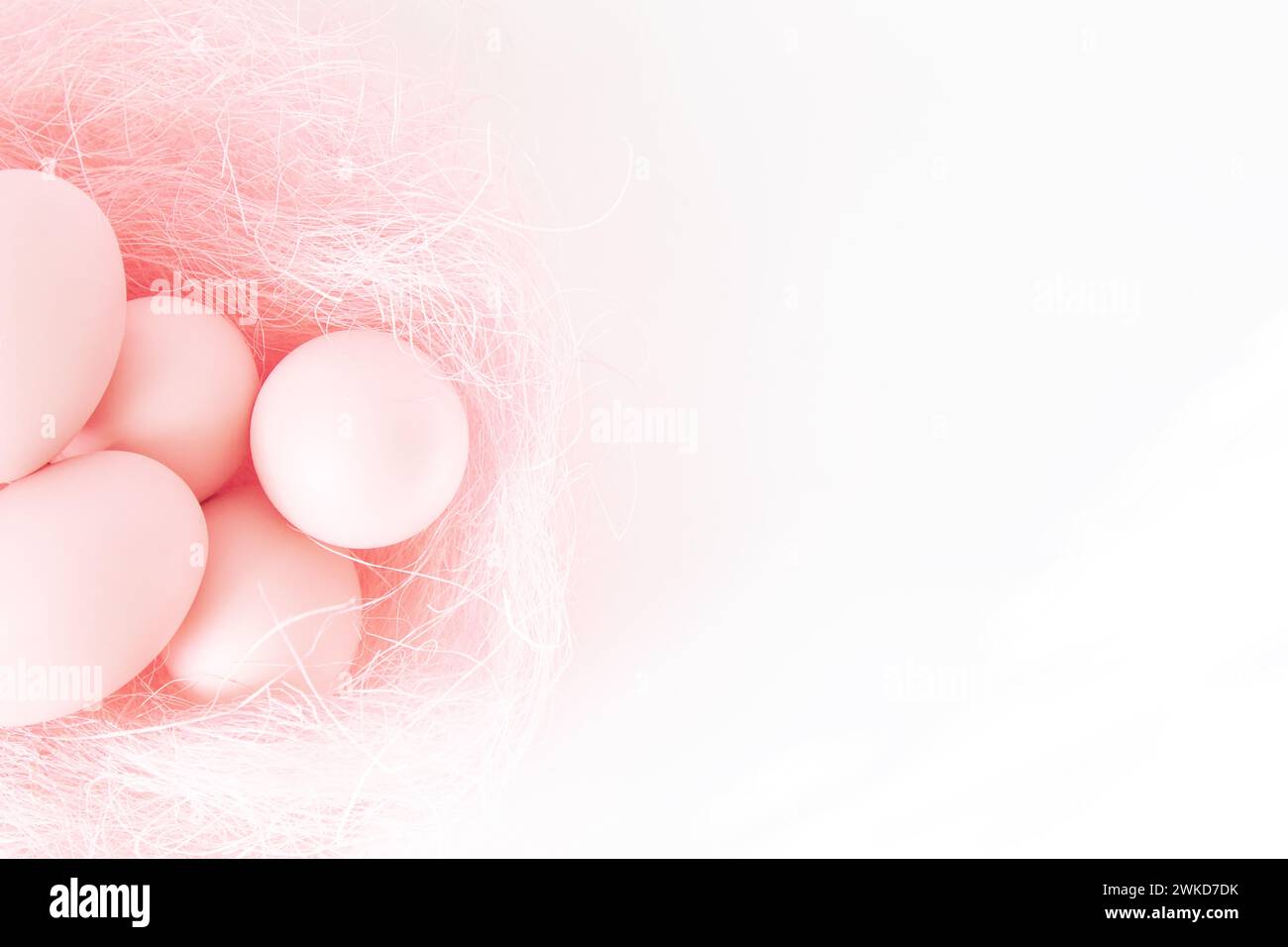 Top view of soft pink Easter eggs lying in a pink nest. Horizontal ...