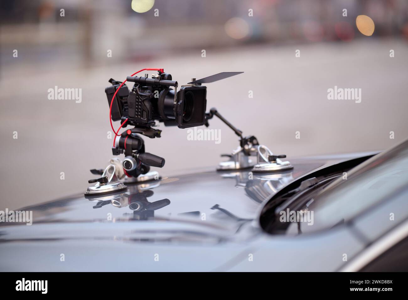 A professional camera rig is mounted on a vehicle, ready for filming ...