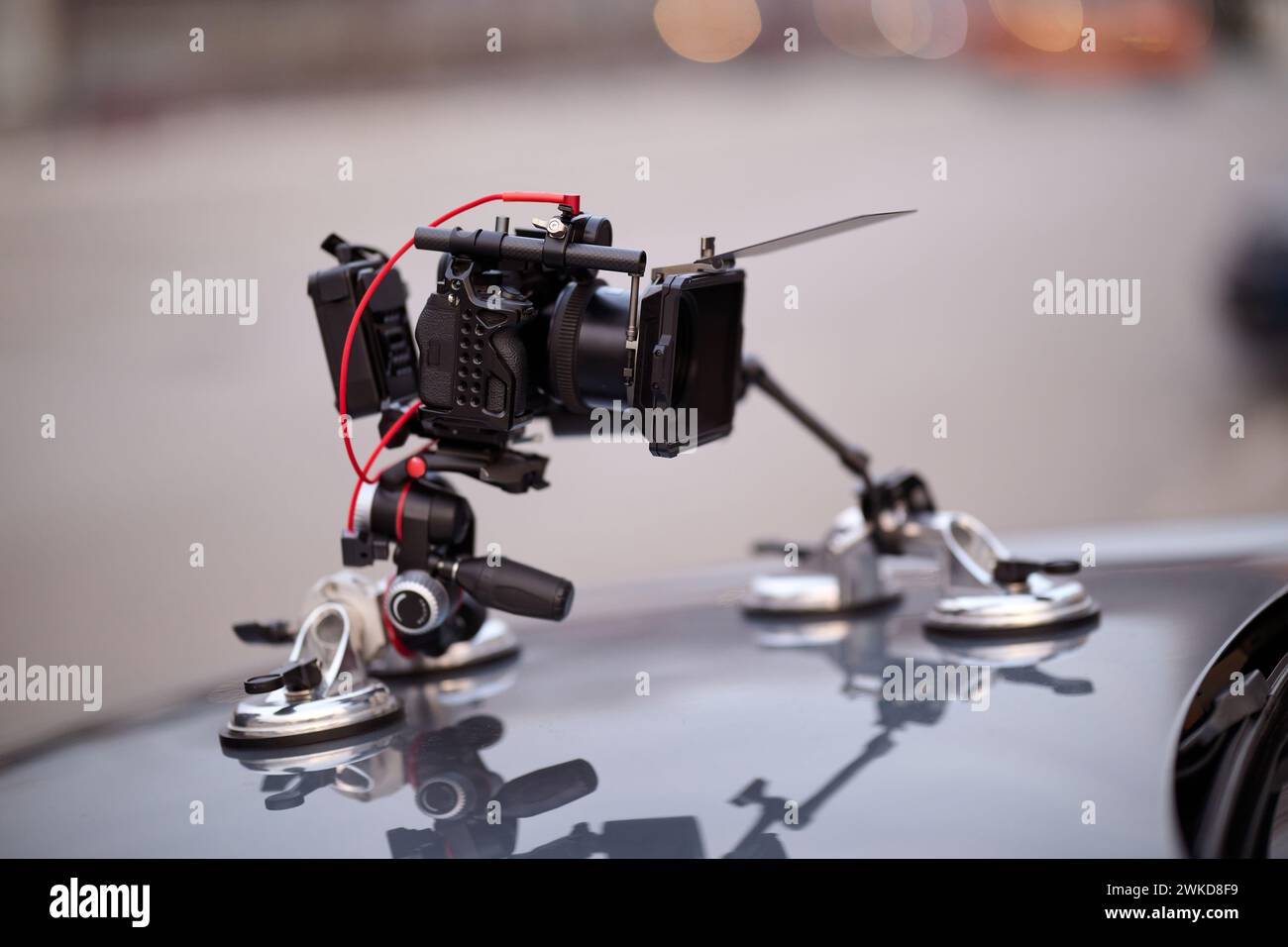 A professional camera rig is mounted on a vehicle, ready for filming ...