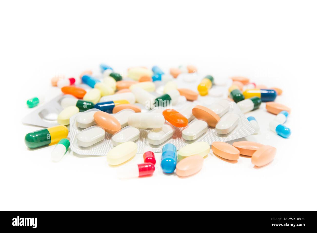 Assorted pharmaceutical pills and colorful capsules isolated on a white ...