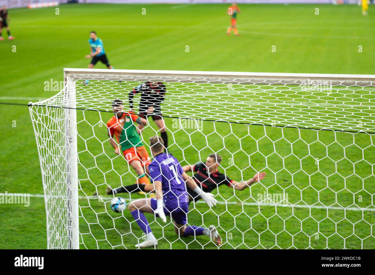 Soccer goal bar and action under the goal in the background Stock Photo - Alamy