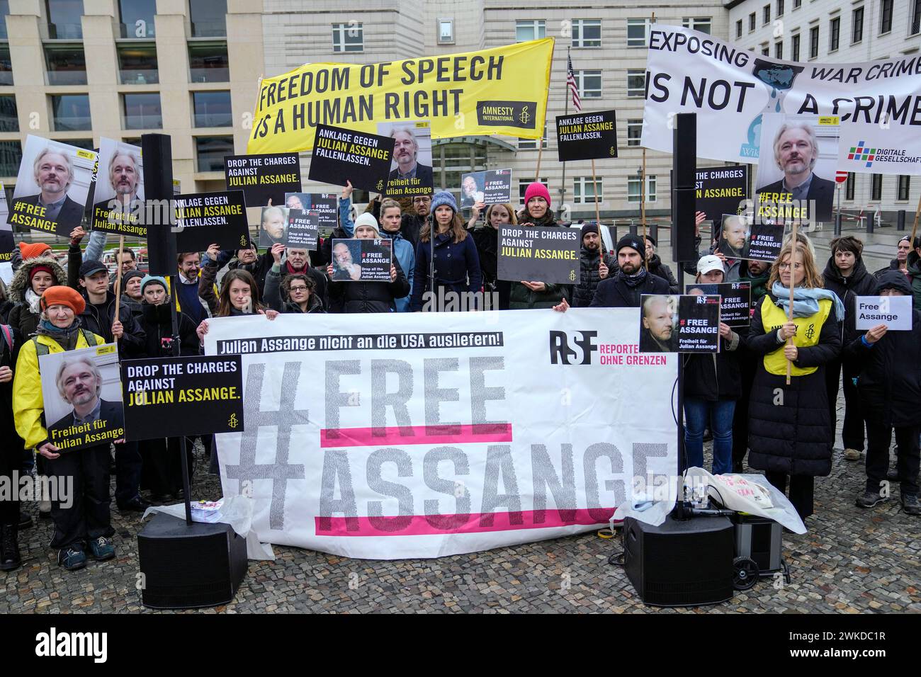 Demonstrators hold banners during a rally in support of Julian Assange ...