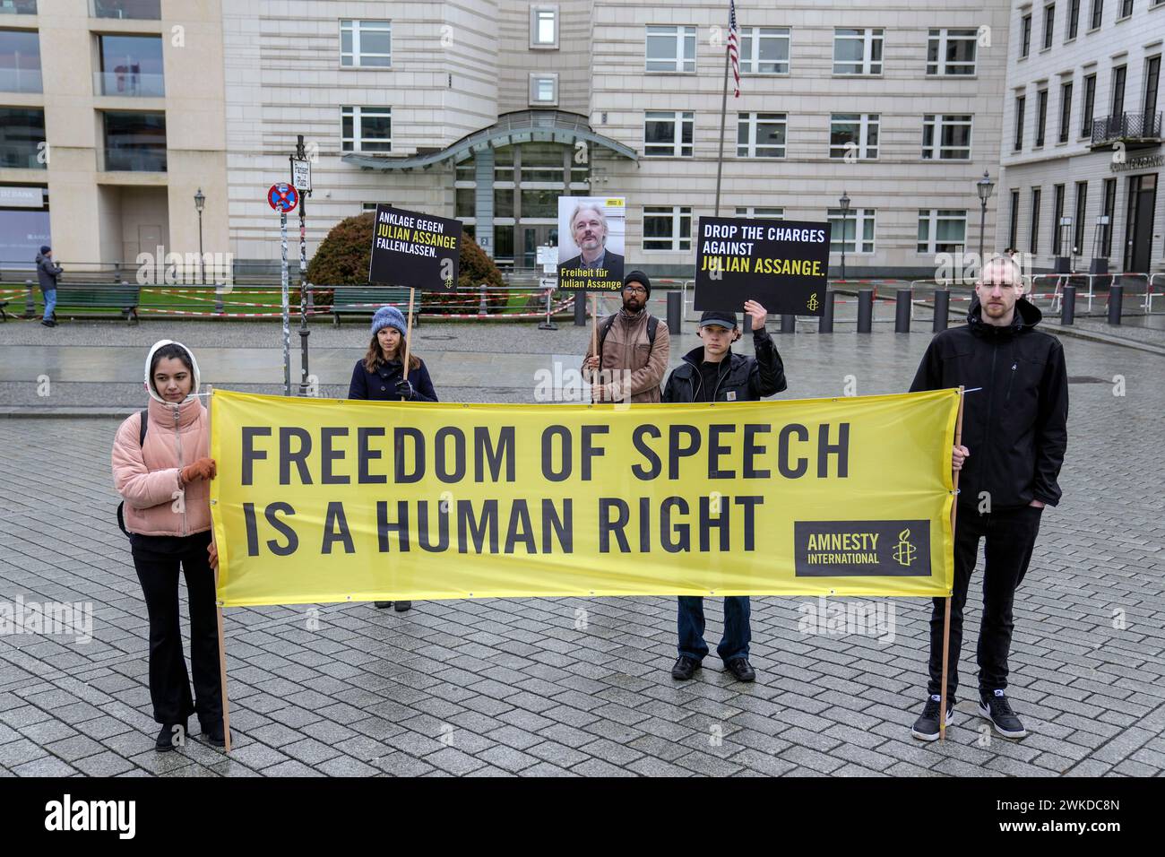 Demonstrators hold banners during a rally in support of Julian Assange ...