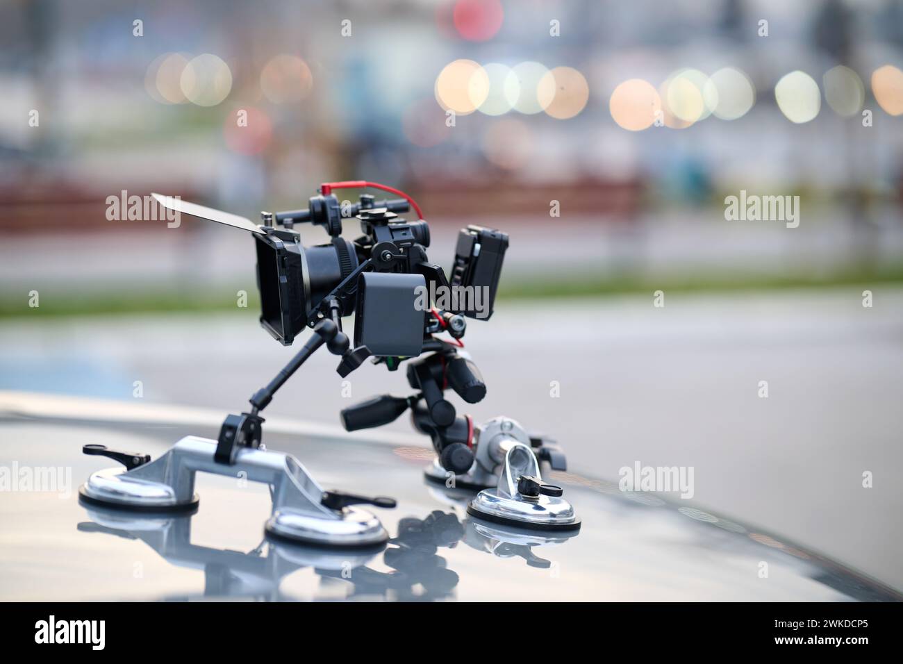 A professional camera rig is mounted on a vehicle, ready for filming ...