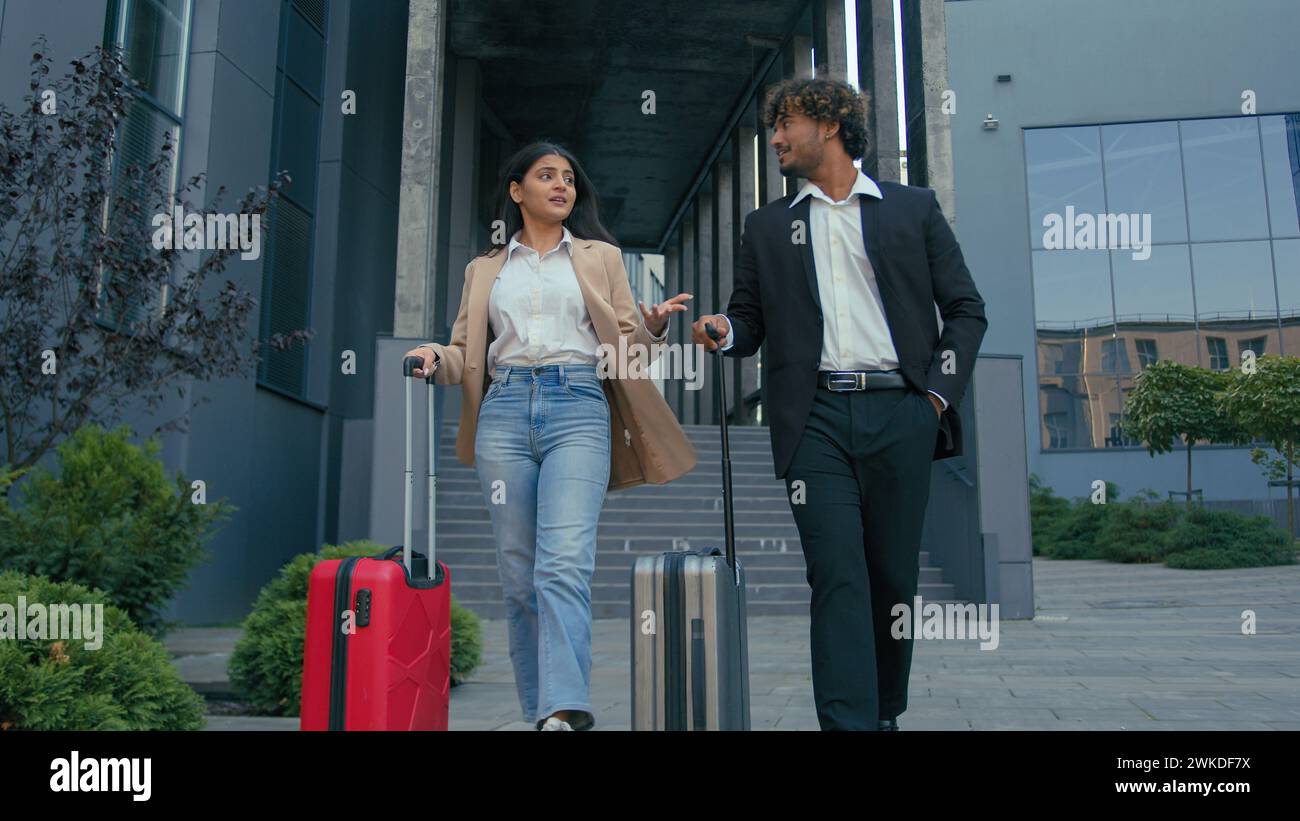 Two formal people walking at city outdoors outside airport arriving ...