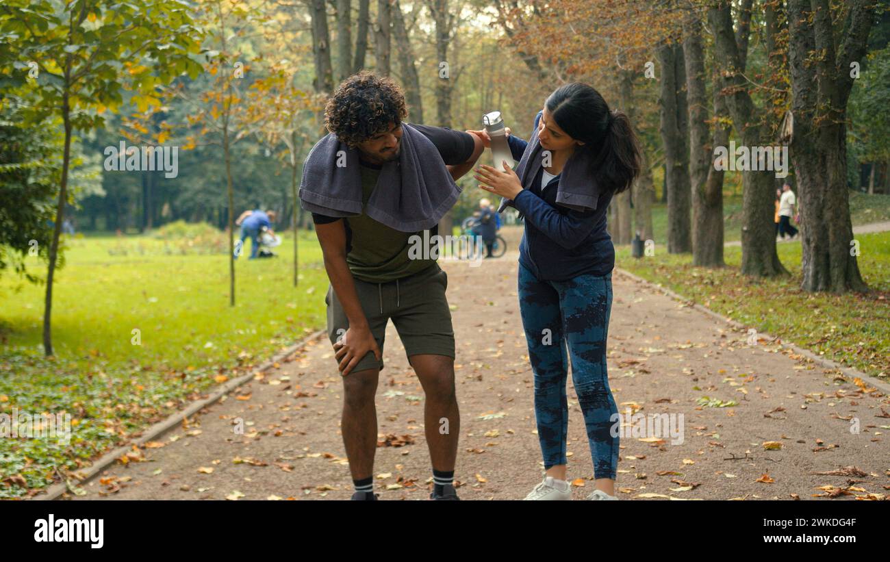 Outdoors in nature park Indian Arabian couple friends man woman stop ...