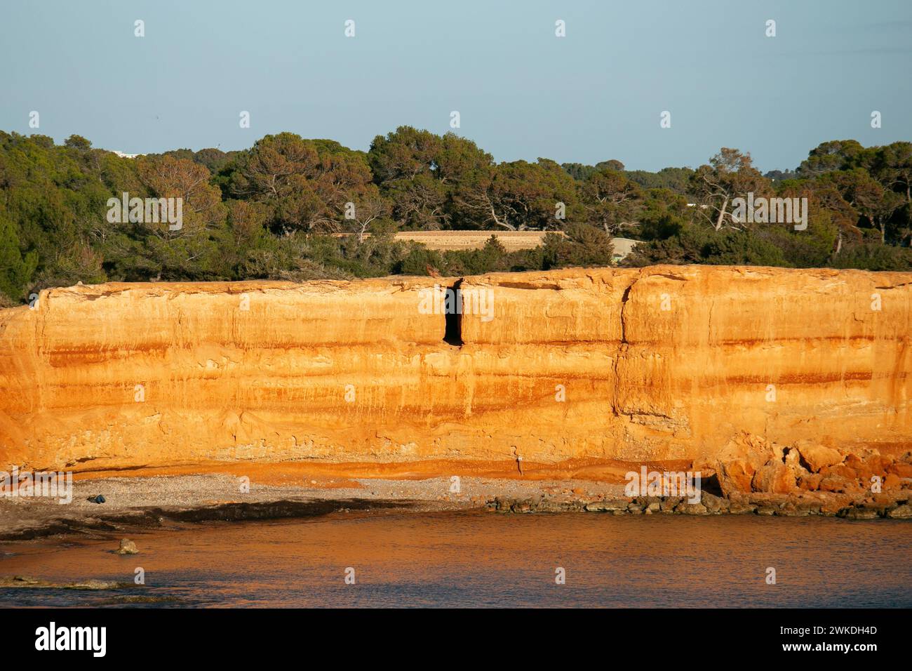 Sa Caleta beach in Ibiza. Beautiful beach with reddish rock and crystal ...