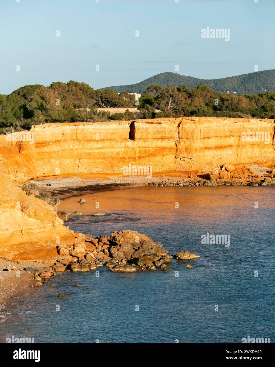 Sa Caleta beach in Ibiza. Beautiful beach with reddish rock and crystal ...