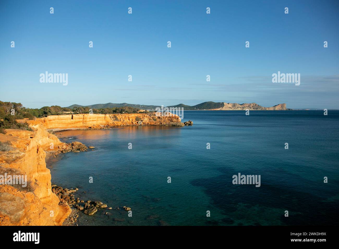 Sa Caleta beach in Ibiza. Beautiful beach with reddish rock and crystal ...