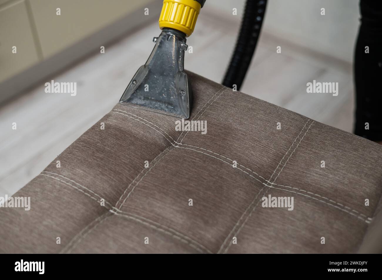 Dry cleaning a fabric chair Stock Photo - Alamy