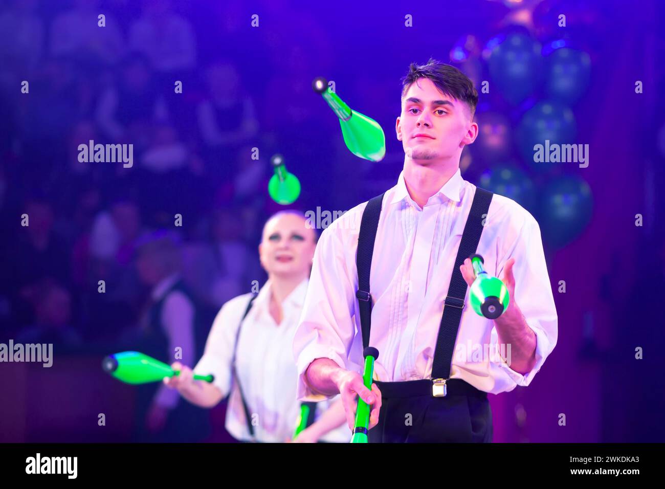 Circus jugglers perform a routine with clubs and perform in the arena ...