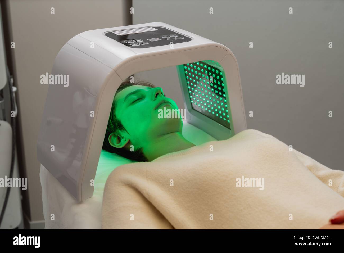 Treatment of women's facial skin using LED light in a beauty salon ...
