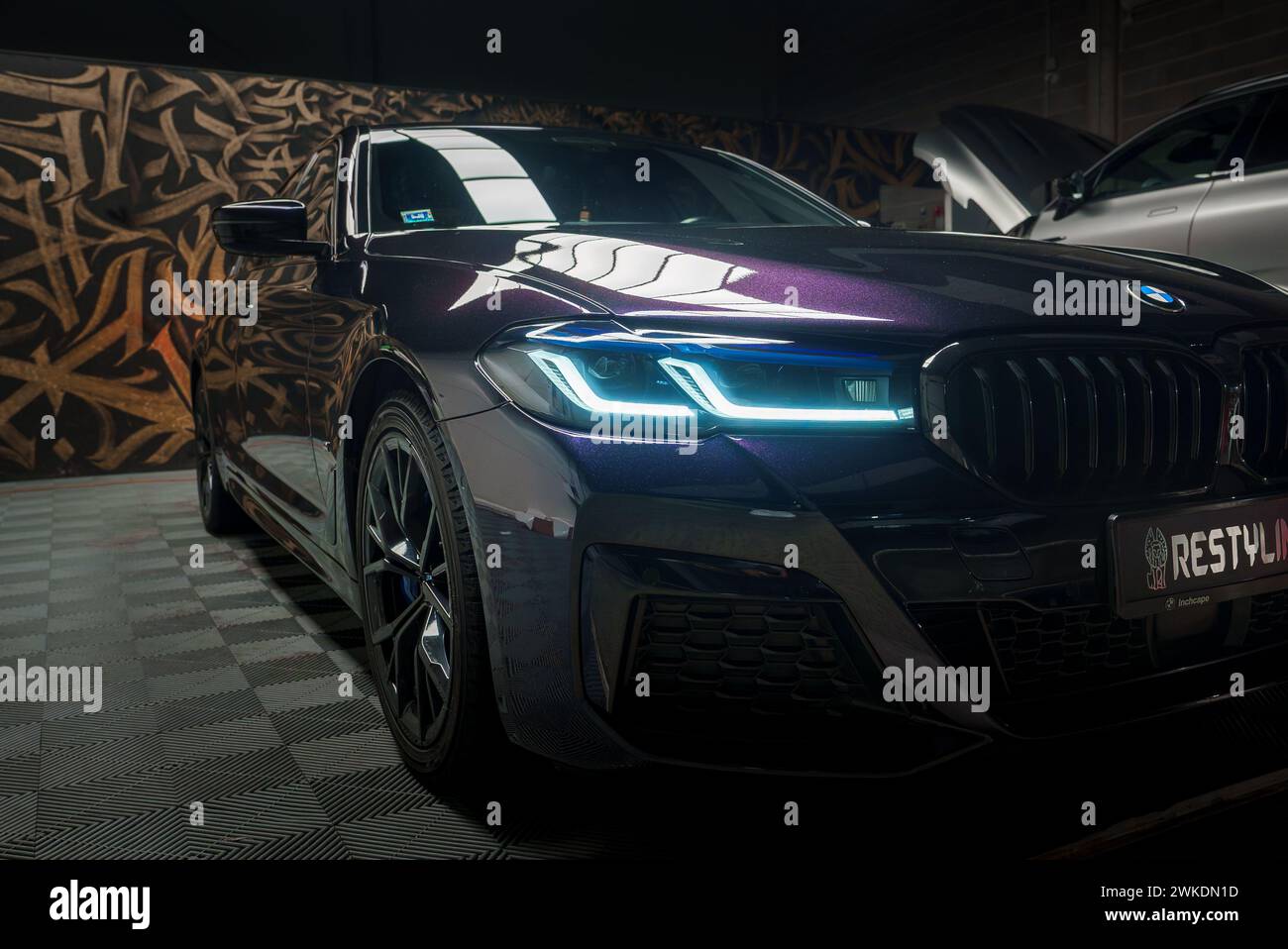 BMW Luxury Vehicle Parked in a Tuning Garage, Graffiti Art Adorning ...