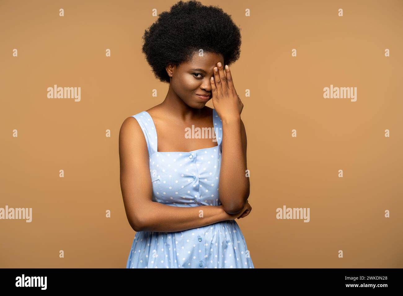 Timid African American woman hiding face confused look to camera ...
