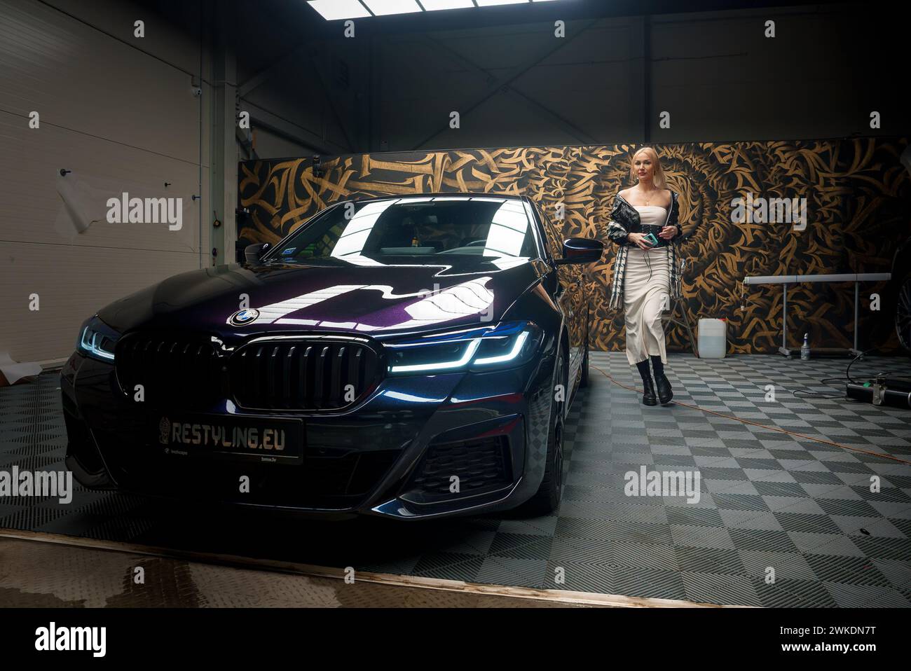 Luxury BMW in HighEnd Tuning Garage with Stylish Female Associate Stock ...