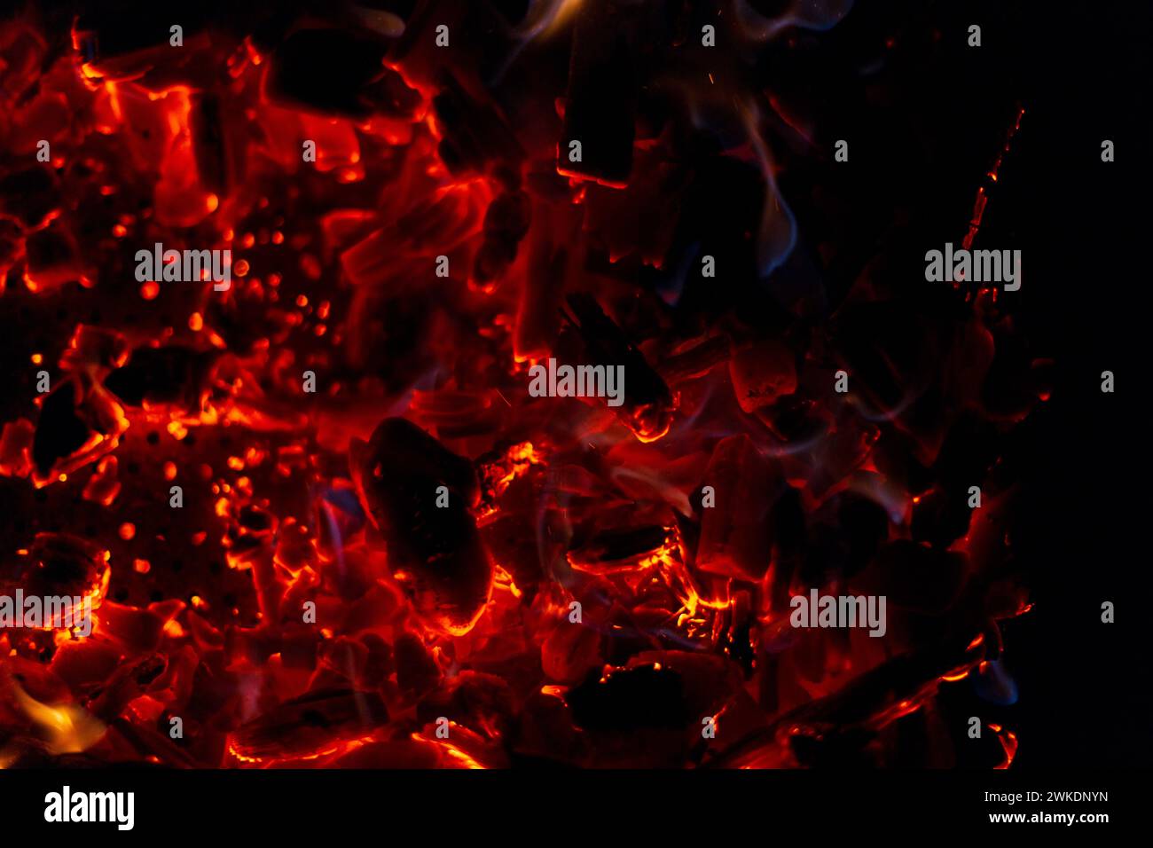 Hot burning coals with sparks on a black background Stock Photo - Alamy