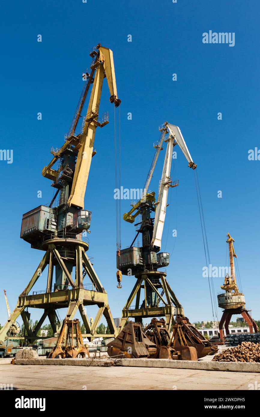 Decommissioned harbor cranes stand idle, symbols of industrial decline ...