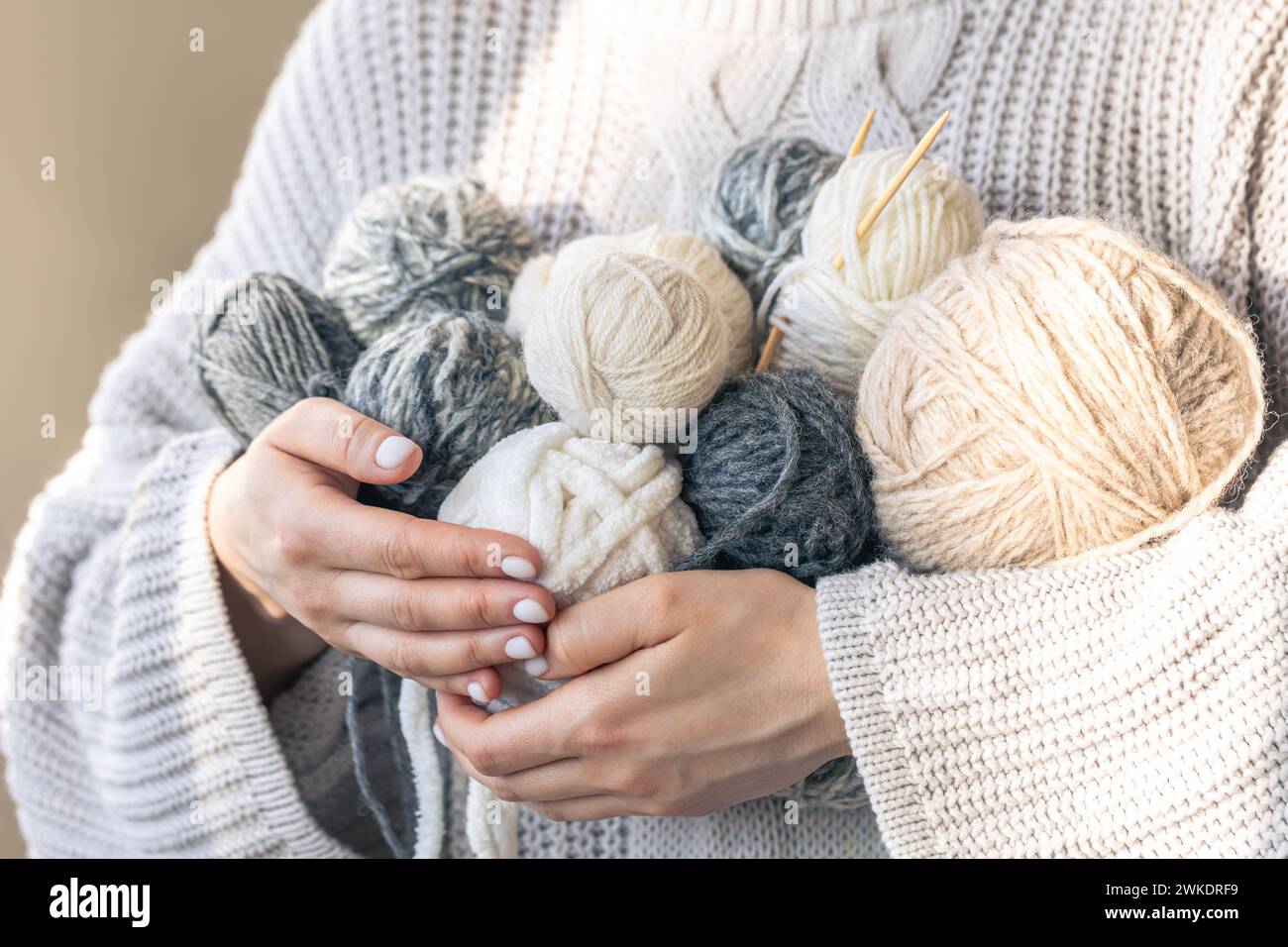 Close-up, woman hands holding several colored balls of thread Stock ...