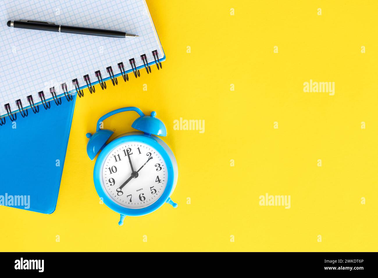 Blue alarm clock and notepads on a yellow background, flat design Stock ...