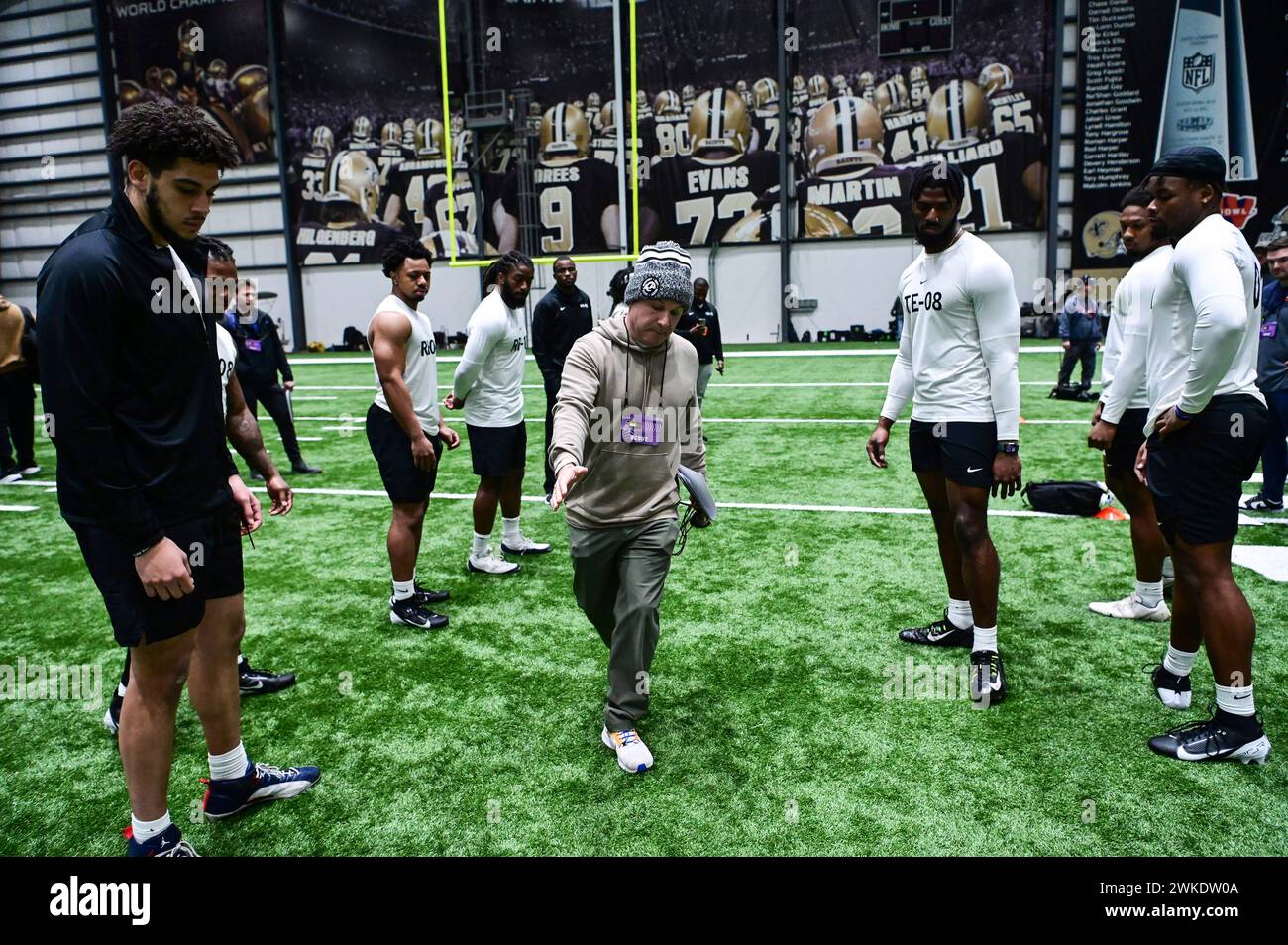 Ted Monago, scout for the Rams, works with players participating in the ...