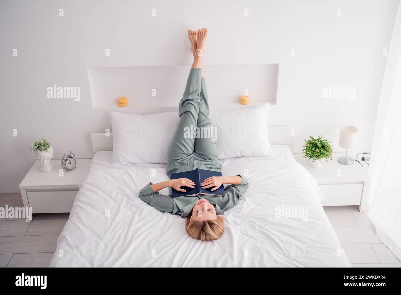 Full body size photo of blonde hair girl tired reading fiction book ...