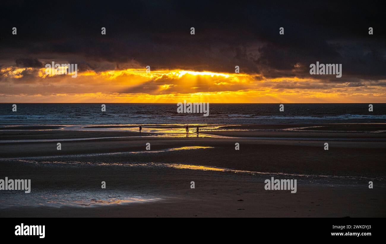 The last sun rays coming through the clouds on Blackpool beach Stock ...
