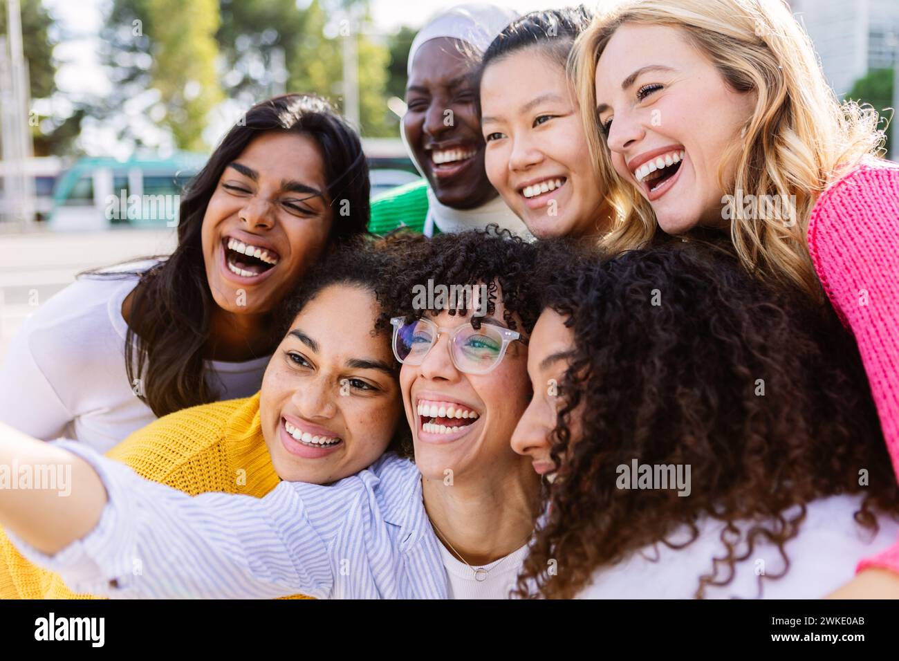 Happy group of young diverse women laughing and smiling together at ...