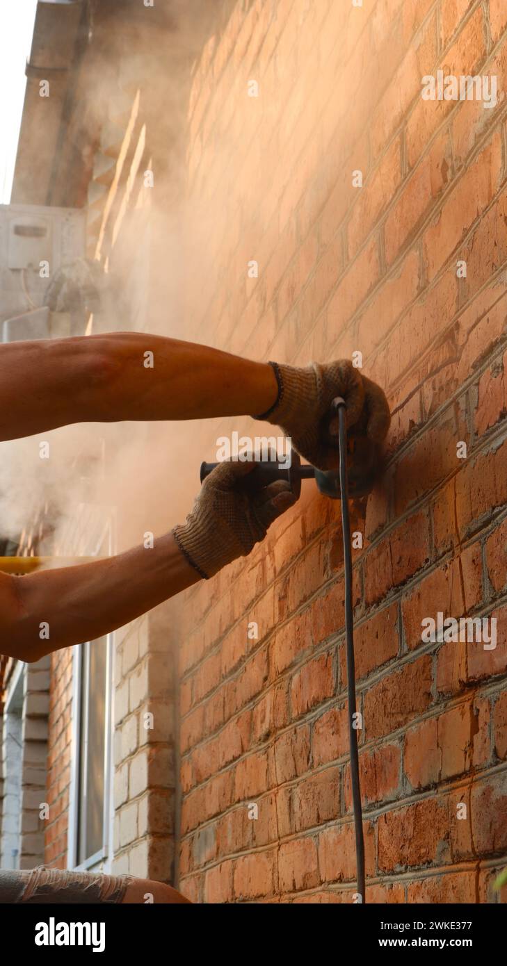 cutting a contour to make a window opening in a brick wall with an ...