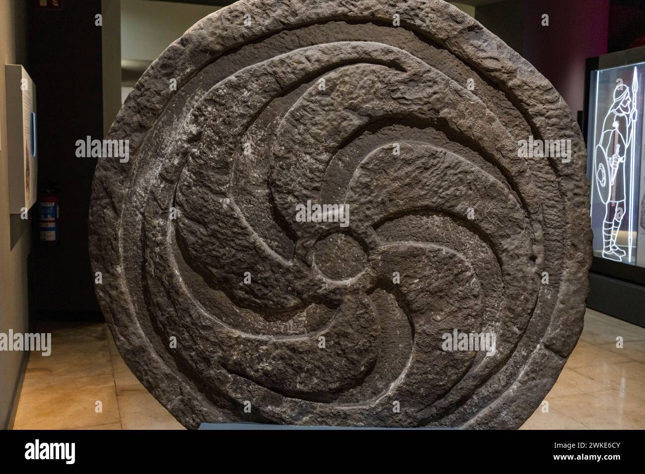 five-armed swastika in relief, second Lombera stele, giant disc-shaped ...
