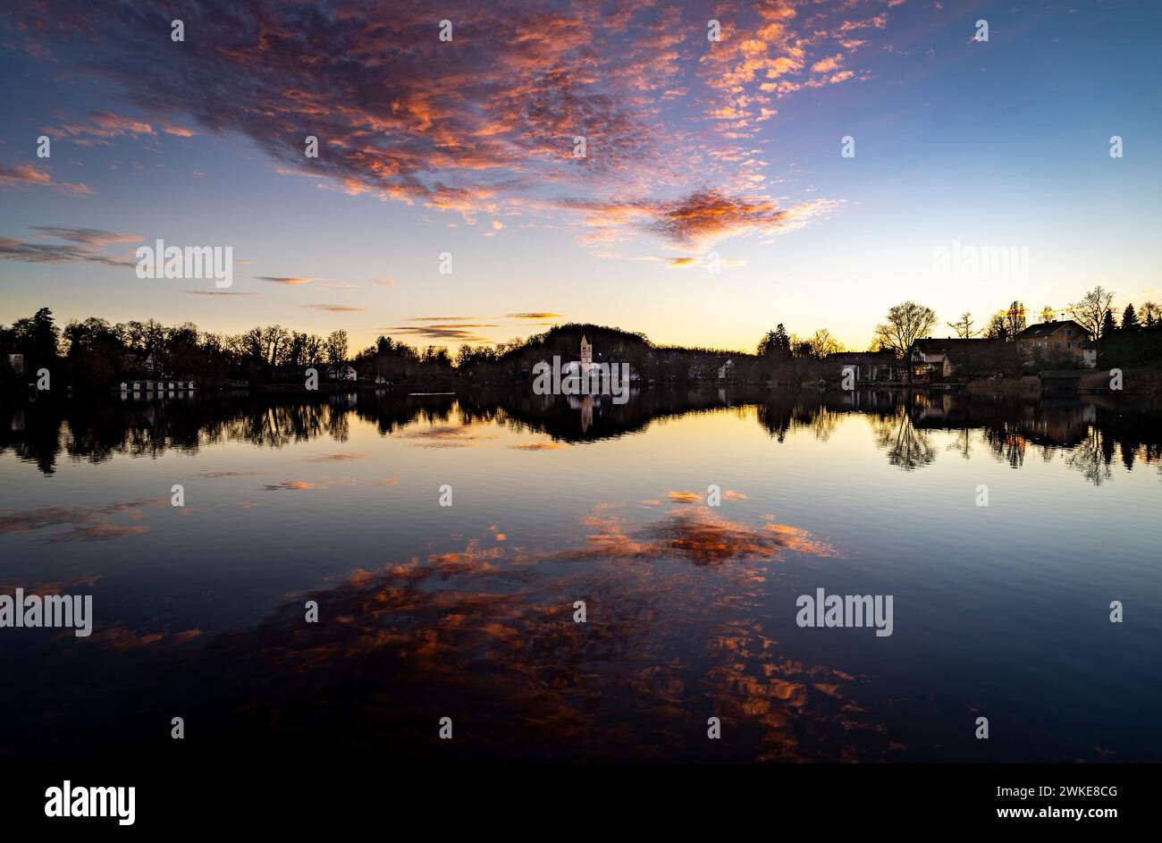 The lake Weßling, Bavaria, and its church at sunset on the last day of ...