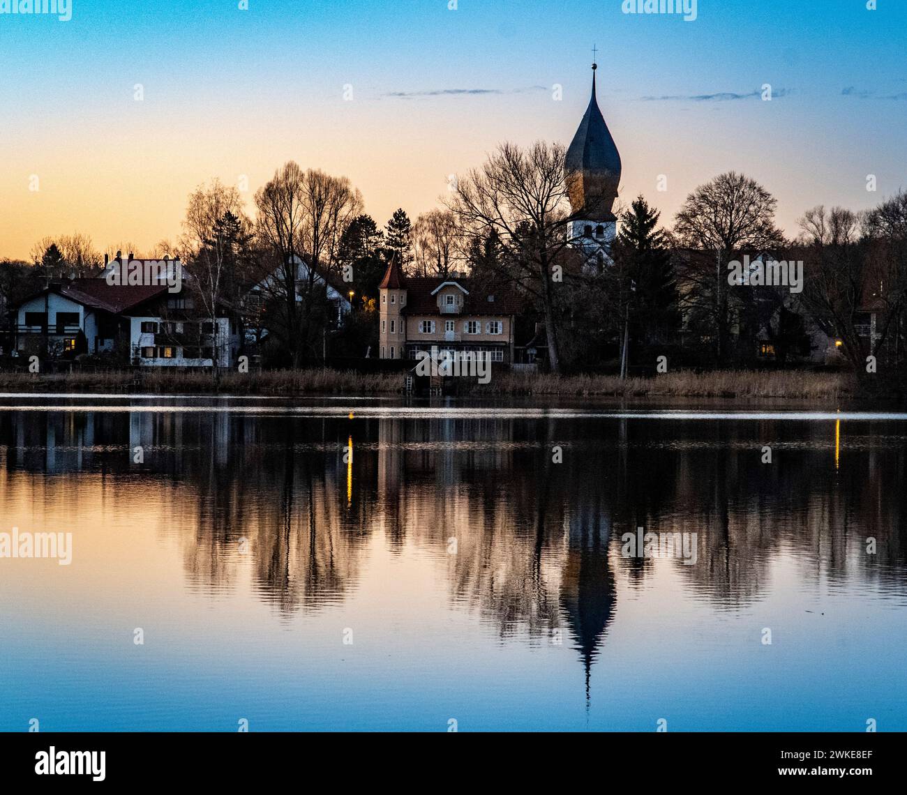The lake Weßling, Bavaria, and its church at sunset on the last day of ...