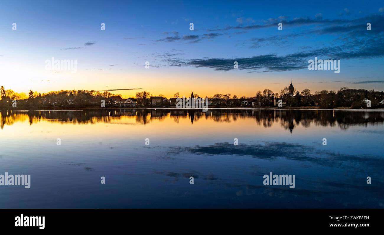 The lake Weßling, Bavaria, and its church at sunset on the last day of ...