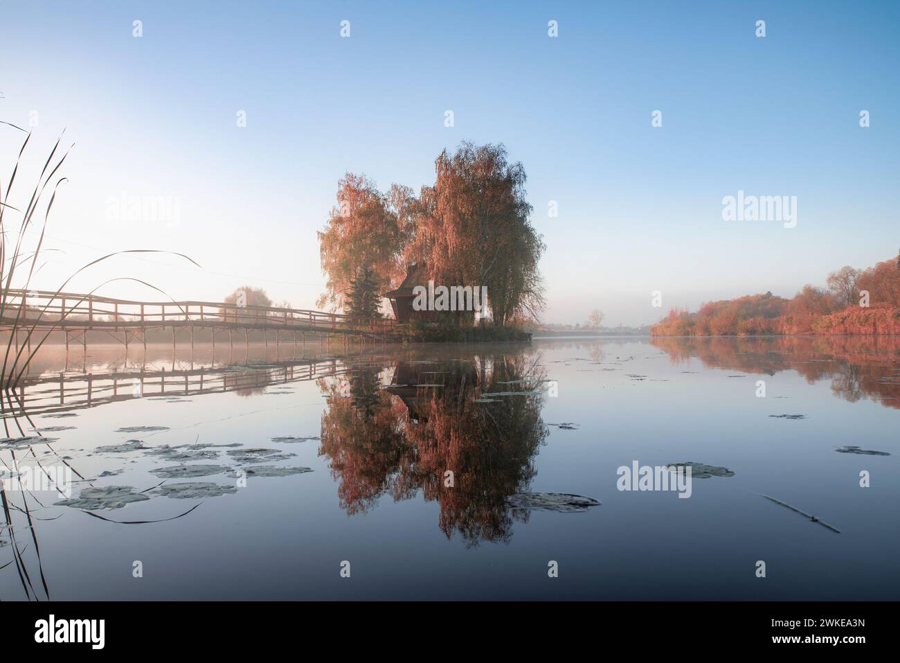 Morning landscape of a small house on an artificial island with a long ...