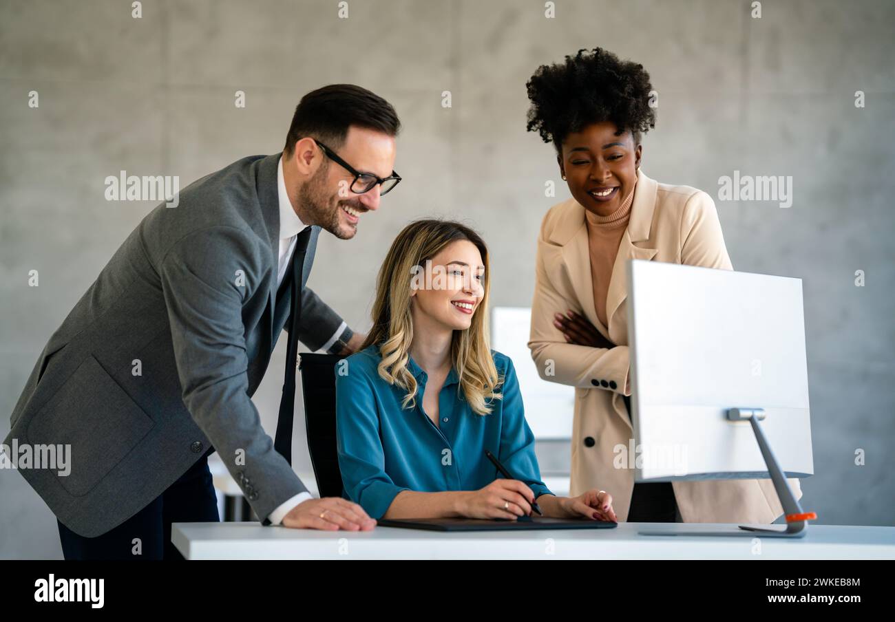 Happy businesspeople laughing while collaborating on a new project in an office Stock Photo - Alamy