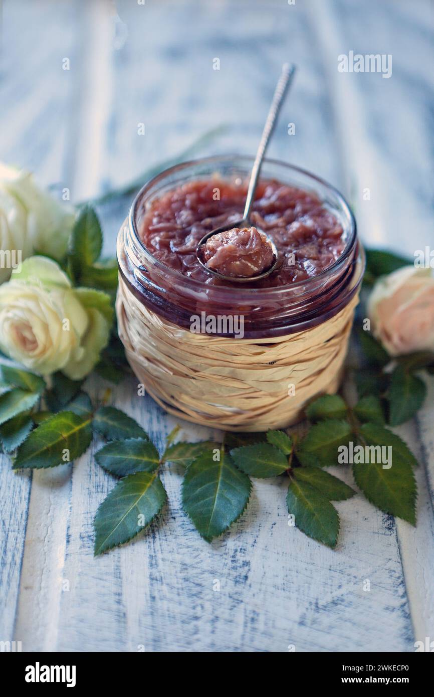 roses jam. food background with a glass jars full of tea rose jam with ...