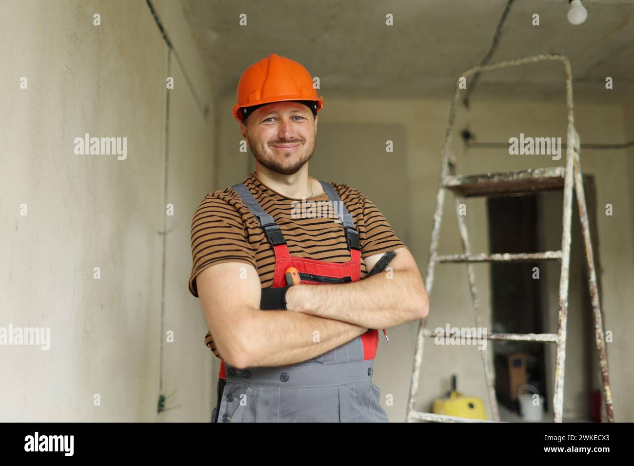Renovation apartment. Portrait of young confident male foreman ...
