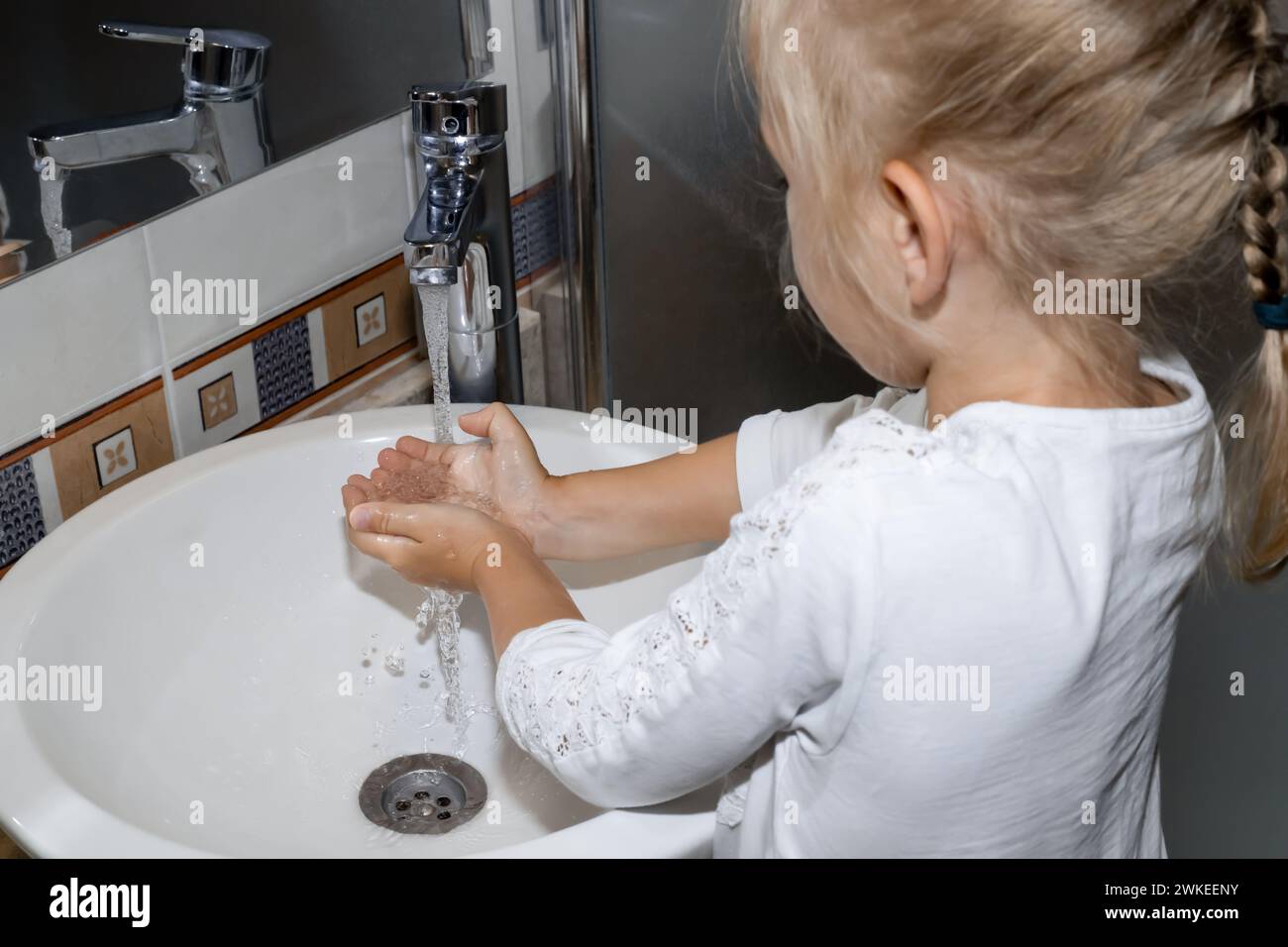 child washing hands in bathroom, view from back Stock Photo - Alamy