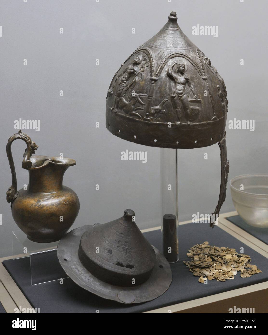 Helmet, shield boss, trefoil pitcher and scales from a cuirass used in ...